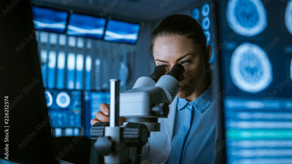 Female Medical Research Scientist Looking Through the Microscope Types ...