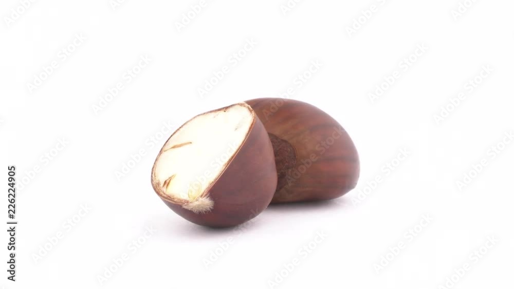 Vidéo Stock One whole and one half cut sweet chestnuts. Cross section ...