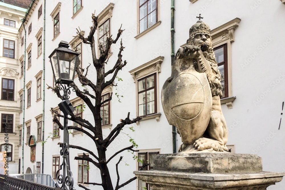 dead tree, sculpture of a lion, sculpture of a lion in a crown ...