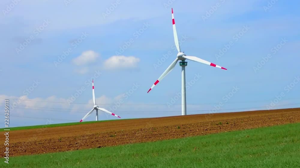 4K footage of wind turbines (aerofoil-powered generators) creating ...