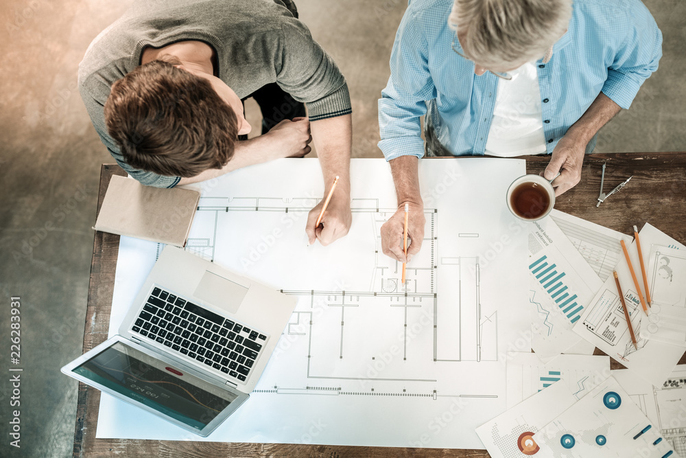 Technical progress. Top view of engineers workplace with a technical ...