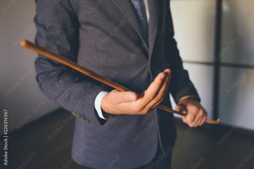 Stockfoto Man with rattan school cane. Strict headmaster with cane ...