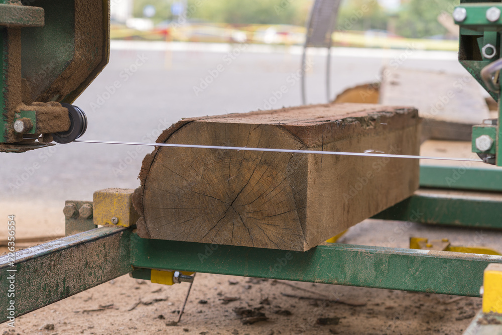 Sawmill. Process of machining logs in equipment sawmill machine saw ...