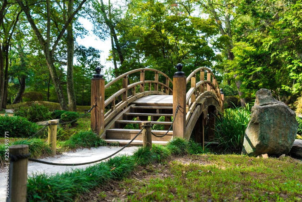 A quaint arched bridge spanning a brook in Richmond, Virginia. This ...