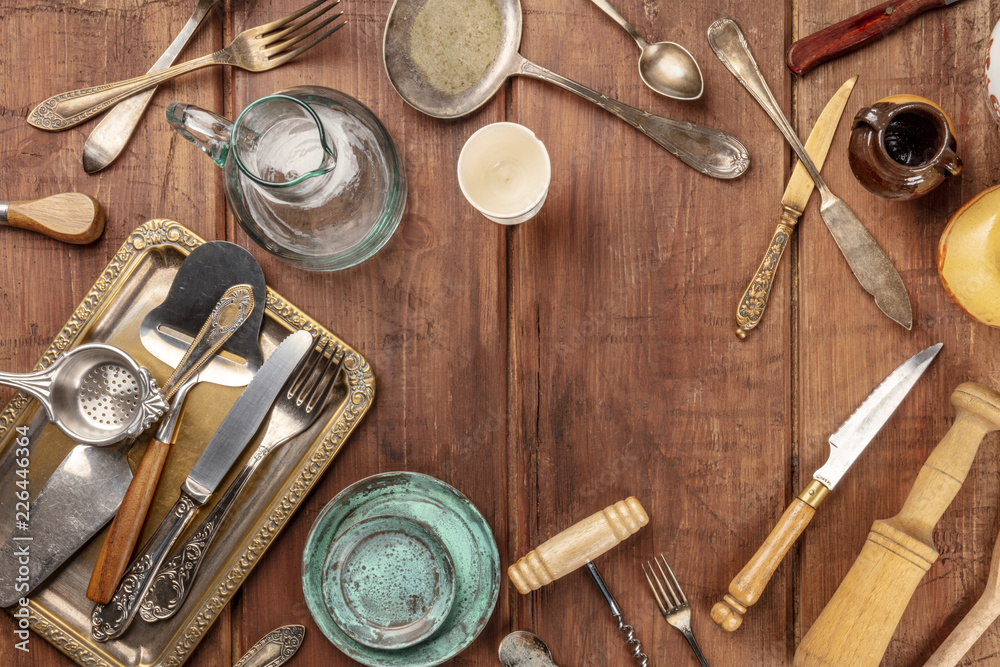 An overhead photo of many vintage kitchen objects and cutlery from an ...