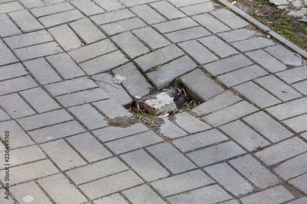 Damaged asphalt road with potholes, caused by freeze-thaw cycles in ...