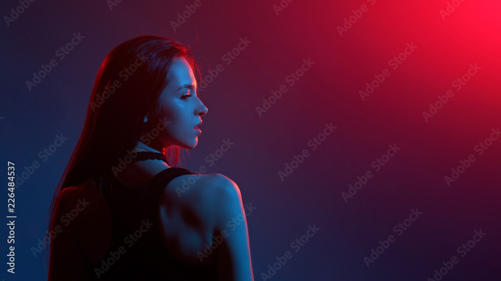 Girl high fashion model in colorful bright light poses, portrait of ...