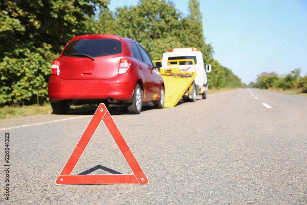 Emergency stop sign with broken car and tow truck on background. Space ...