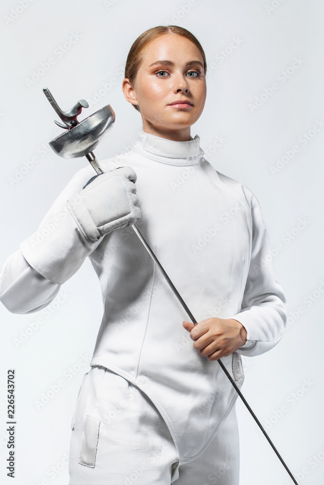 Young fencer athlete wearing fencing costume. holding the sword. Isolated on white background ...