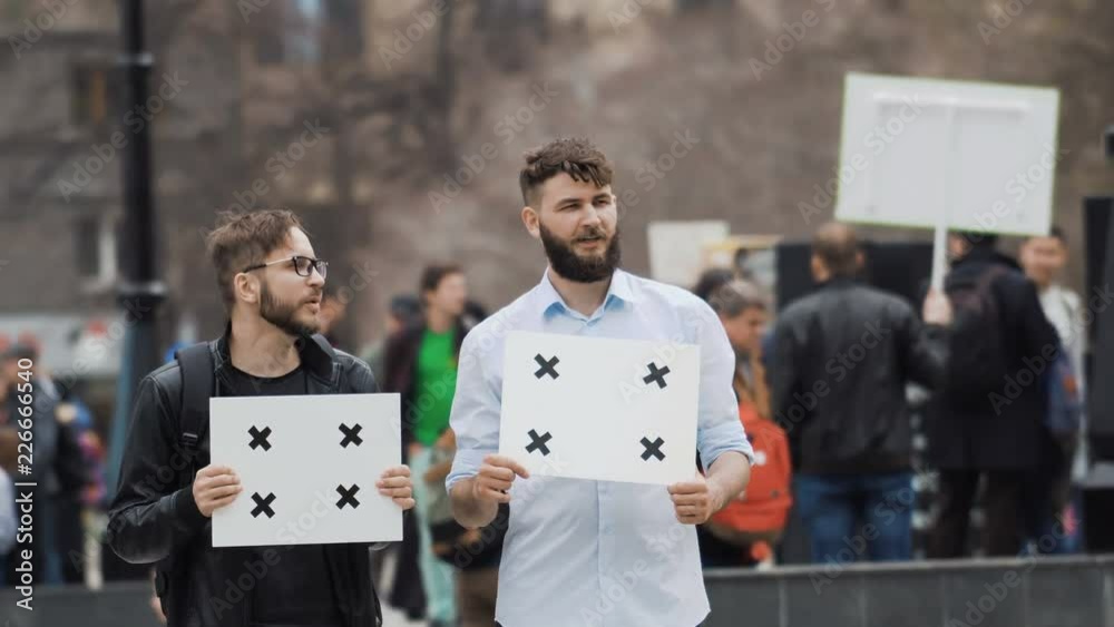 People at the demonstration with banners in their hands look into ...