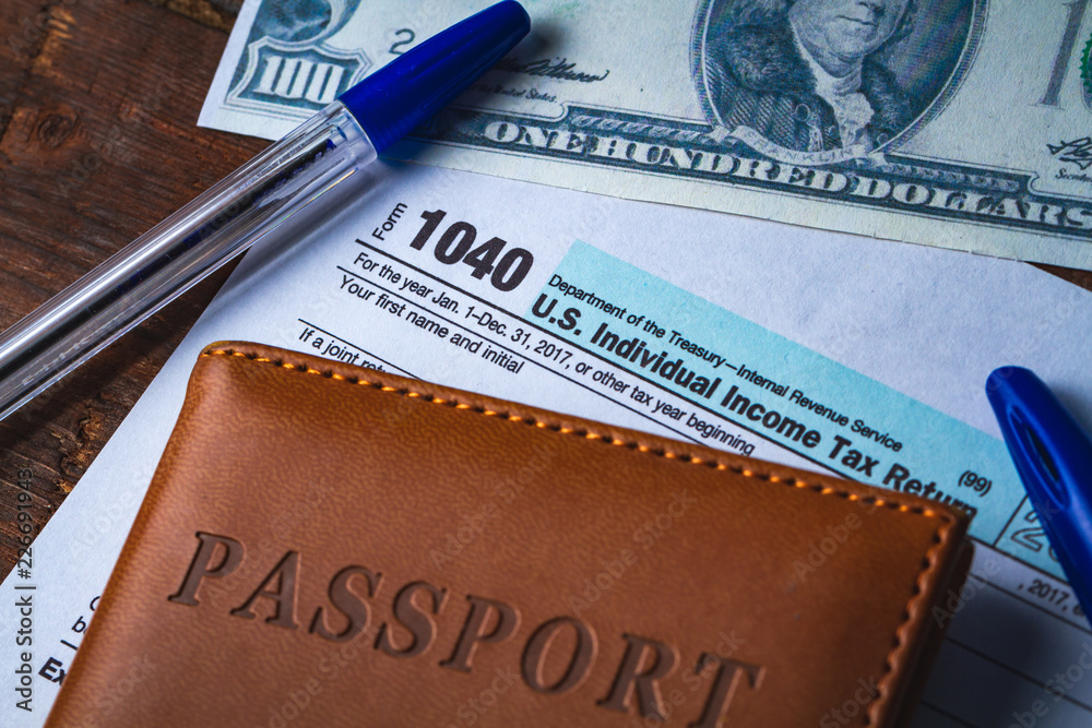 Filling in the U.S. tax form. Tax form 1040, taxpayer passport ...