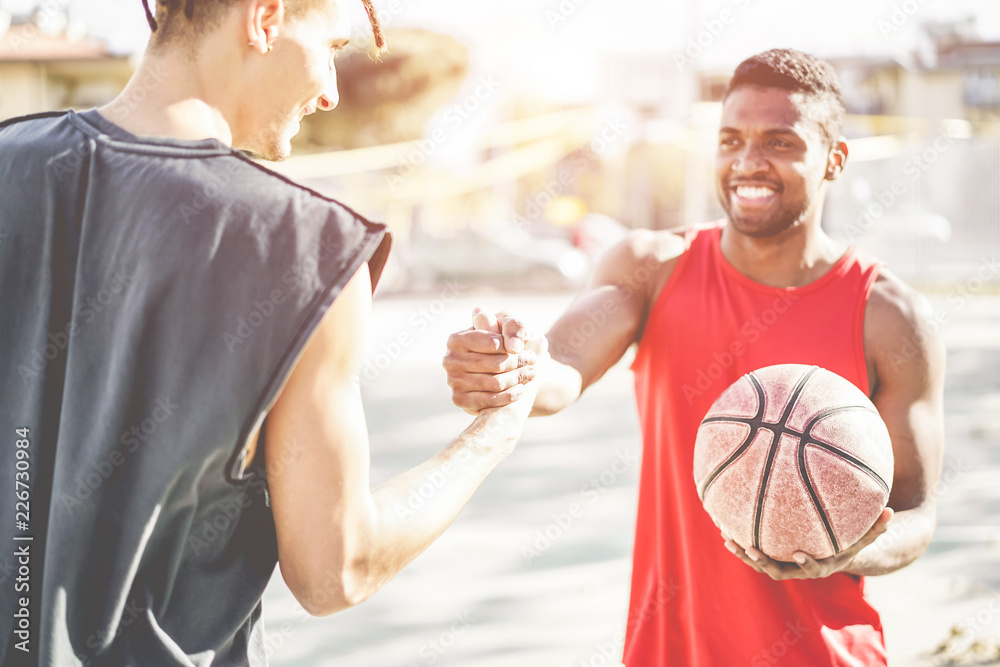 Happy athletes friends playing basketball outdoor in city urban contest ...