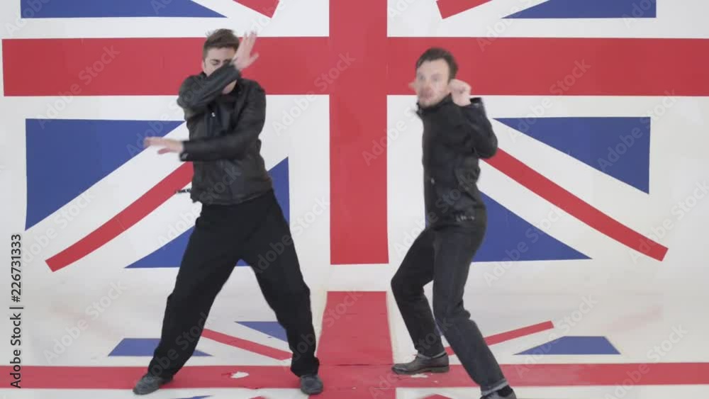 Two young, good-looking, caucasian dark-haired guys in black leather ...