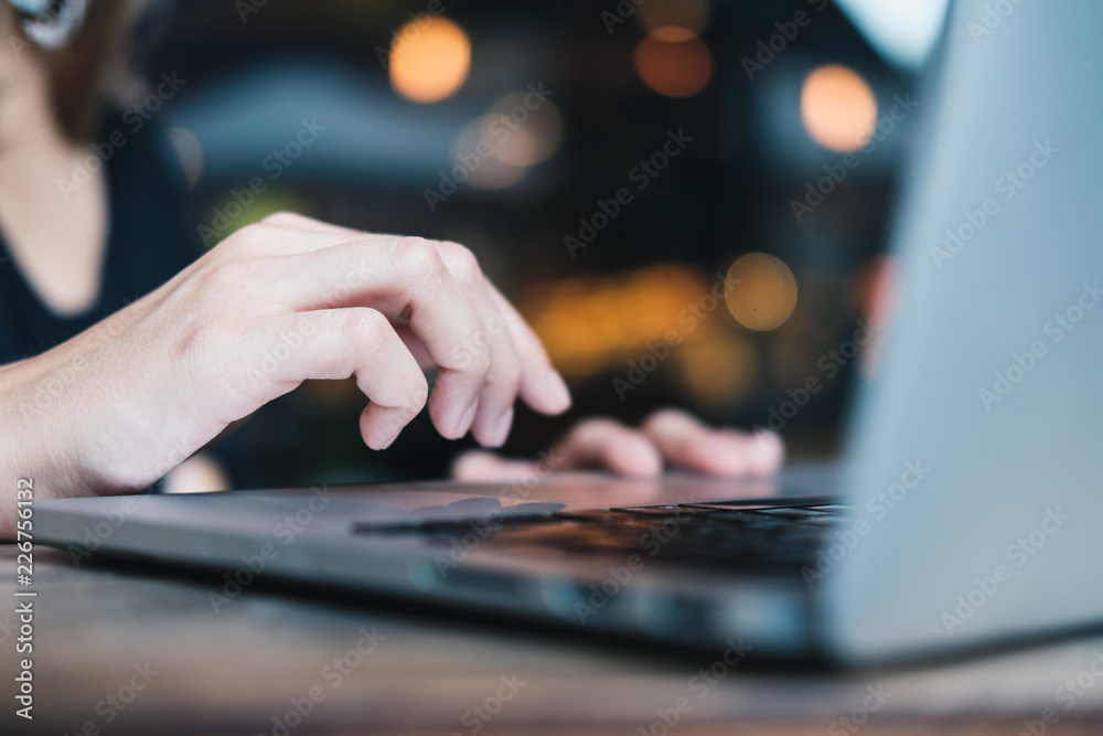Beautiful girl’s hands swiping trackpad. Student studying in cafe ...