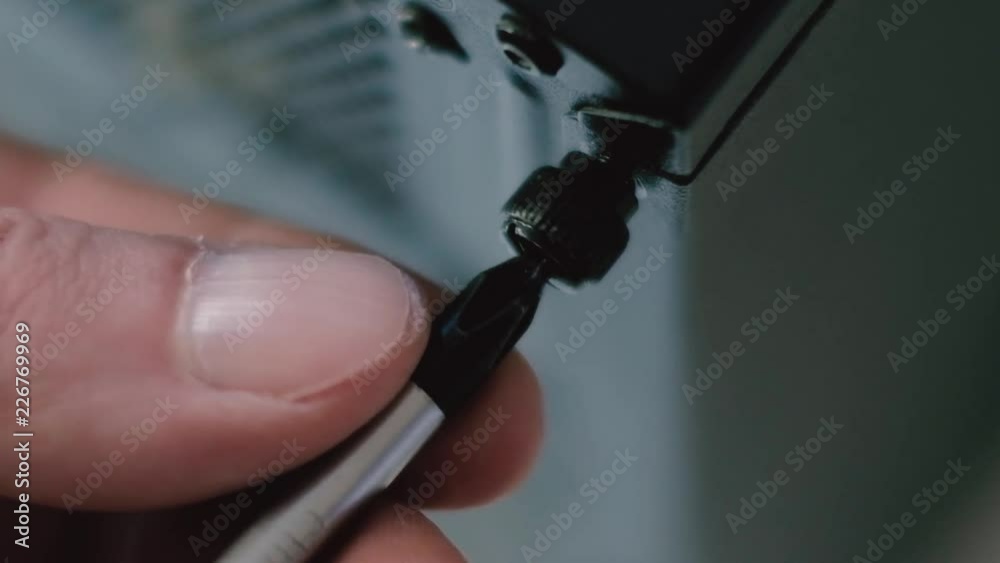 Closeup on mans hands using screwdriver to fix and repair old broken ...