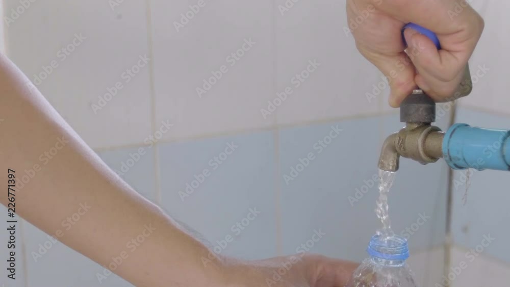 Slow motion 4k of Mans arms & hands holding plastic water container ...