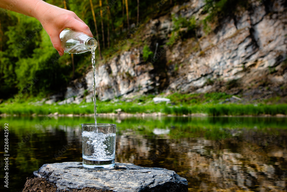 Hand Holding Drinking Water Glass Bottle And Pouring Water Into Glass ...