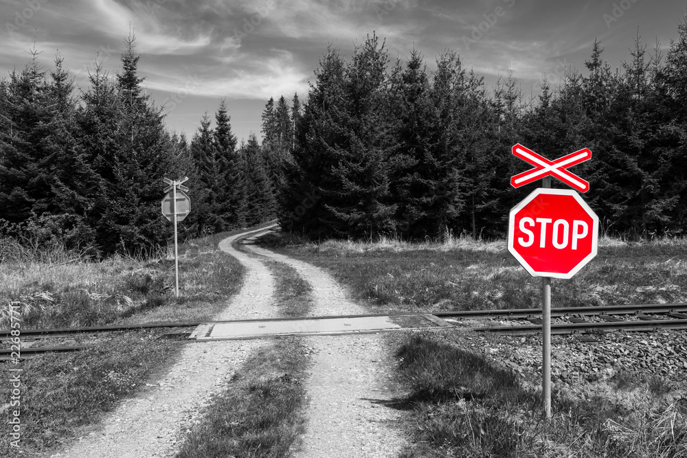 Stop sign on railroad crossing in nature. Red warning signal with ...