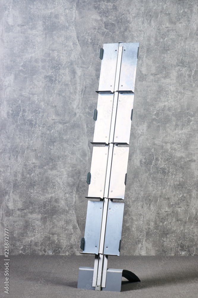 Blank flyer mockup metal transparent holder against gray wall ...