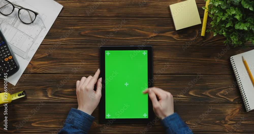 Top view on the black vertical tablet computer on the wooden table of ...