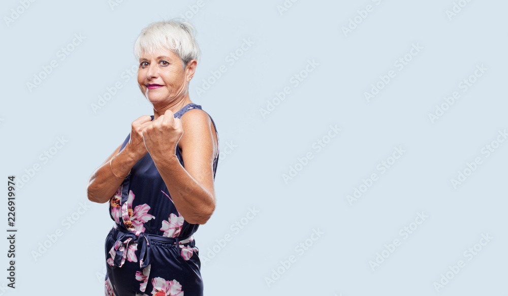 senior cool woman with an angry, aggressive and menacing pose, ready ...