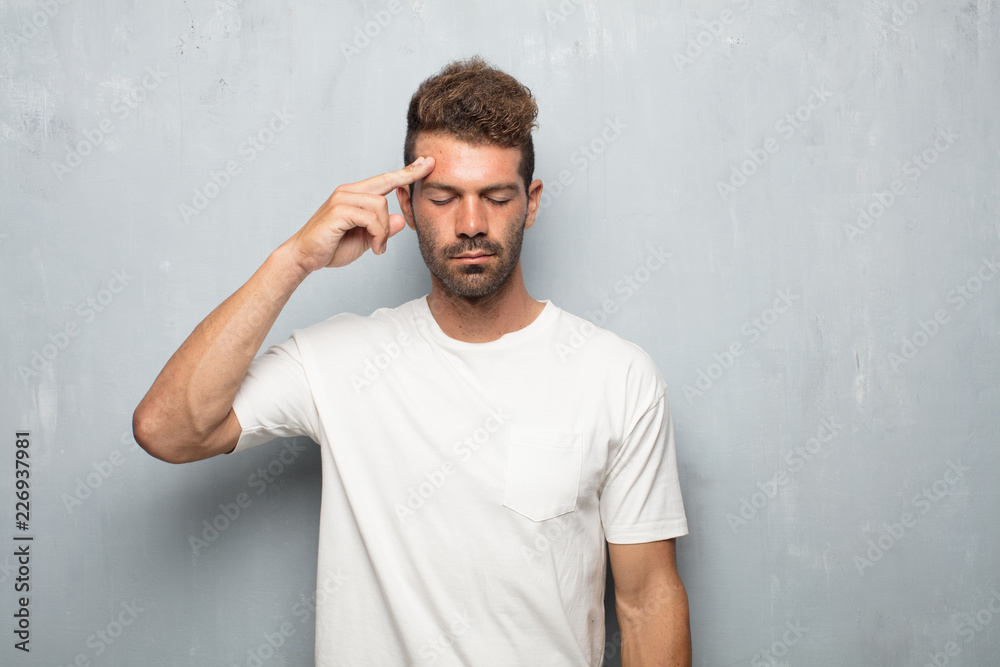 young handsome man Concentrating hard on an idea, with a serious far ...