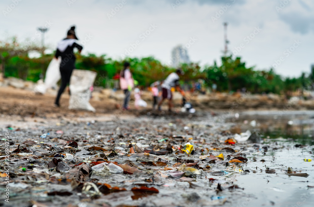 Blurred of volunteers collecting garbage. Beach environment pollution ...