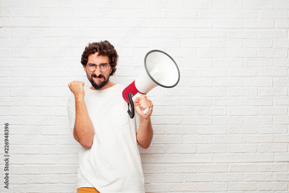 young dumb man with an angry, aggressive and menacing pose, ready for ...