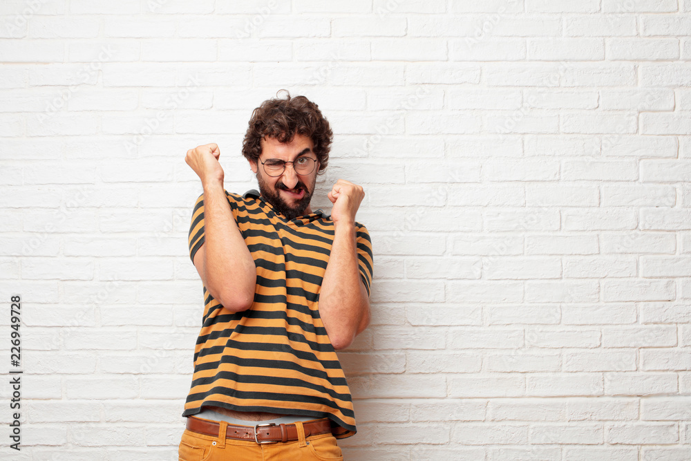 young dumb man with an angry, aggressive and menacing pose, ready for ...
