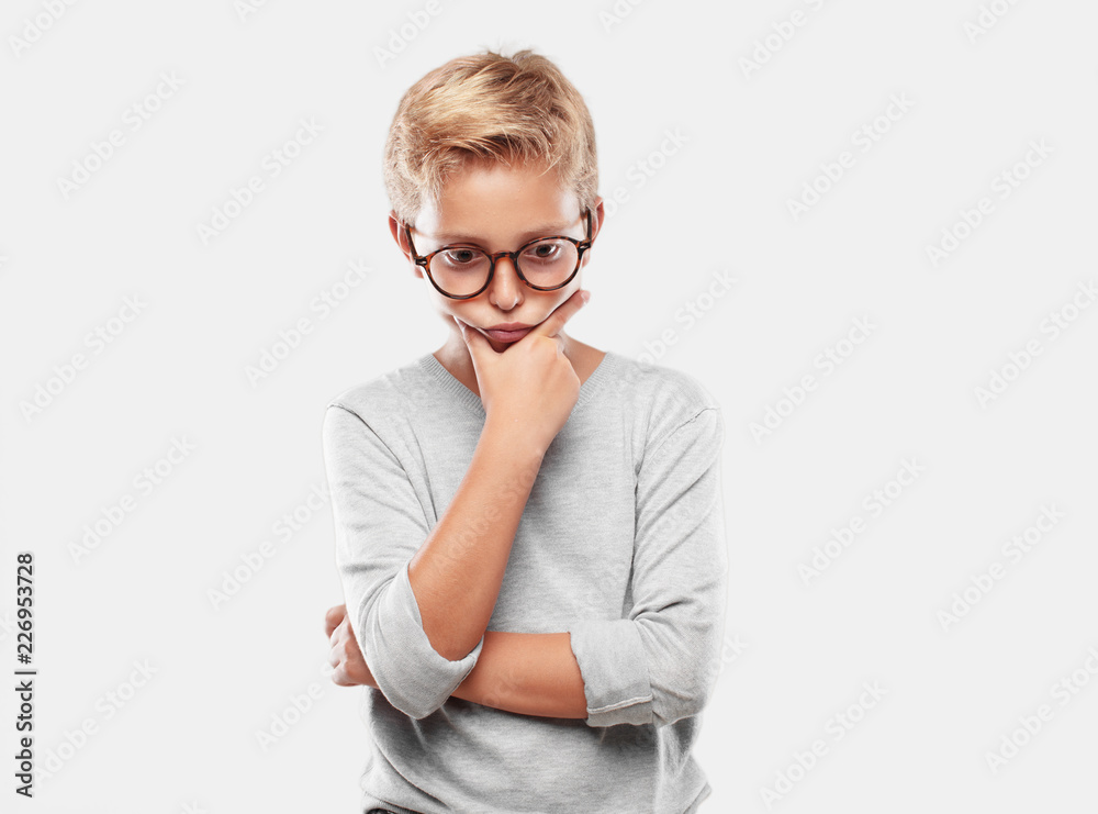 young blonde handsome boy With a confused and thoughtful look, looking ...