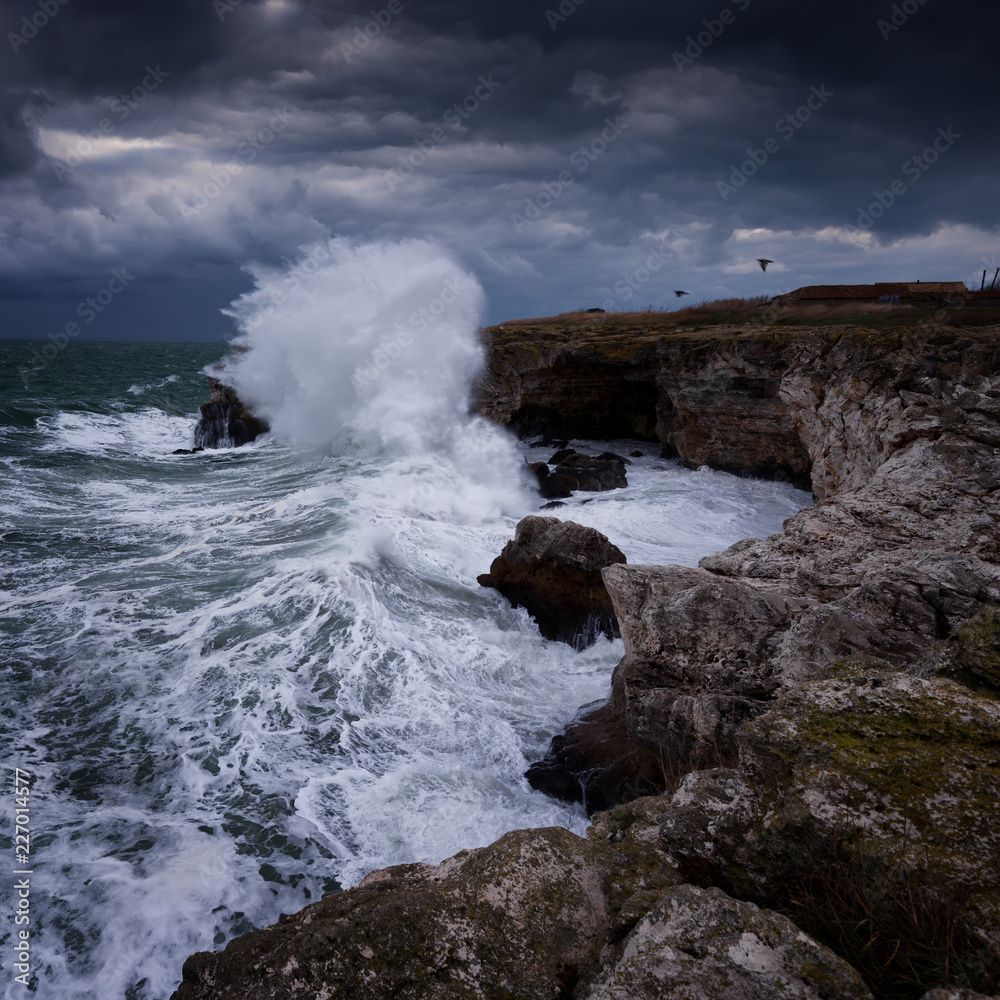 Dramatic nature background - big waves and dark rock in stormy sea ...