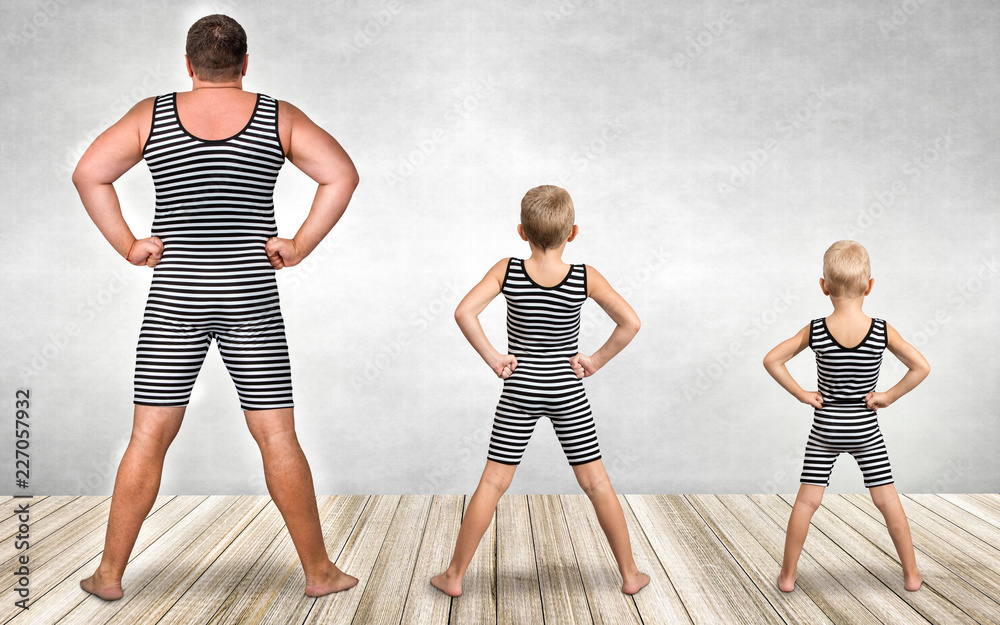 Family of strongman. The father of two sons in vintage costume of ...