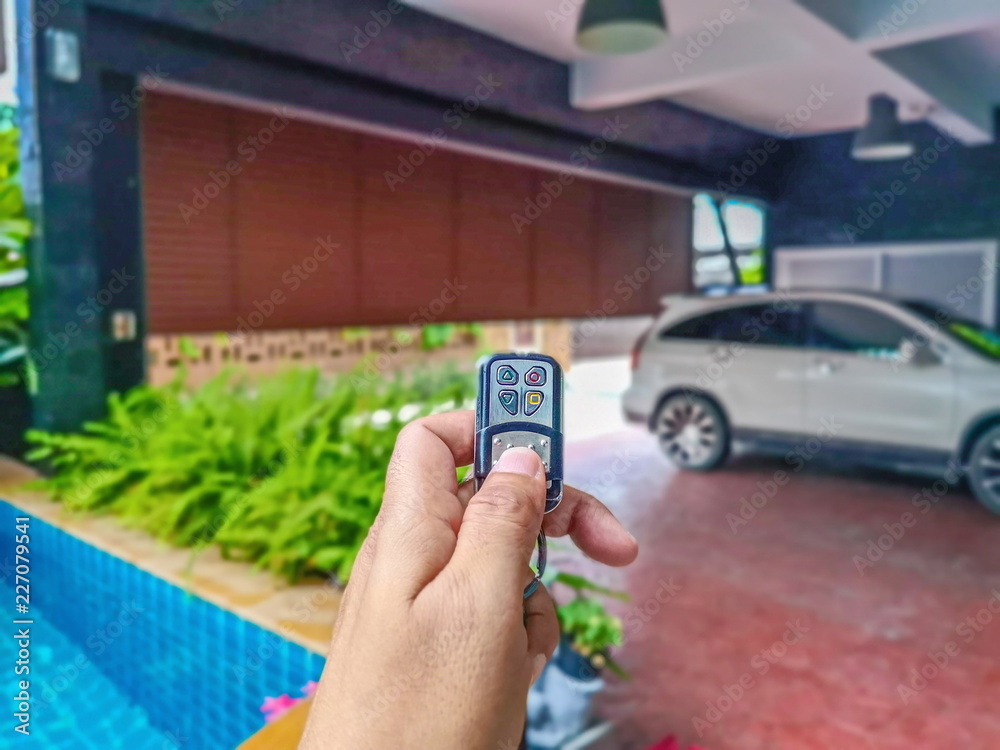 Hand holding the remote to open the sliding door.Remote control door ...