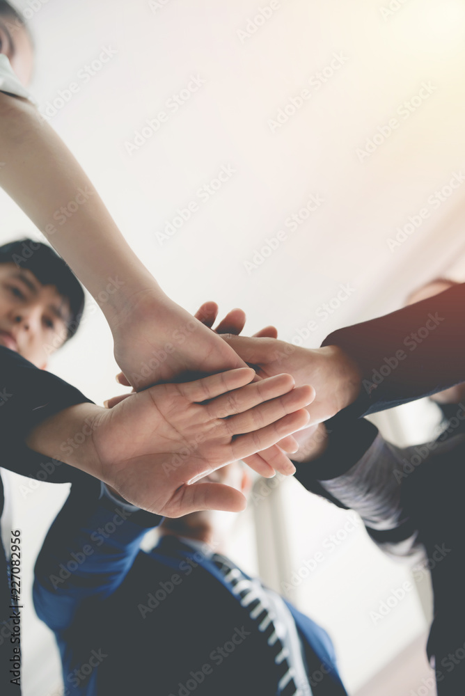 business people team showing unity with their hands together expose the ...