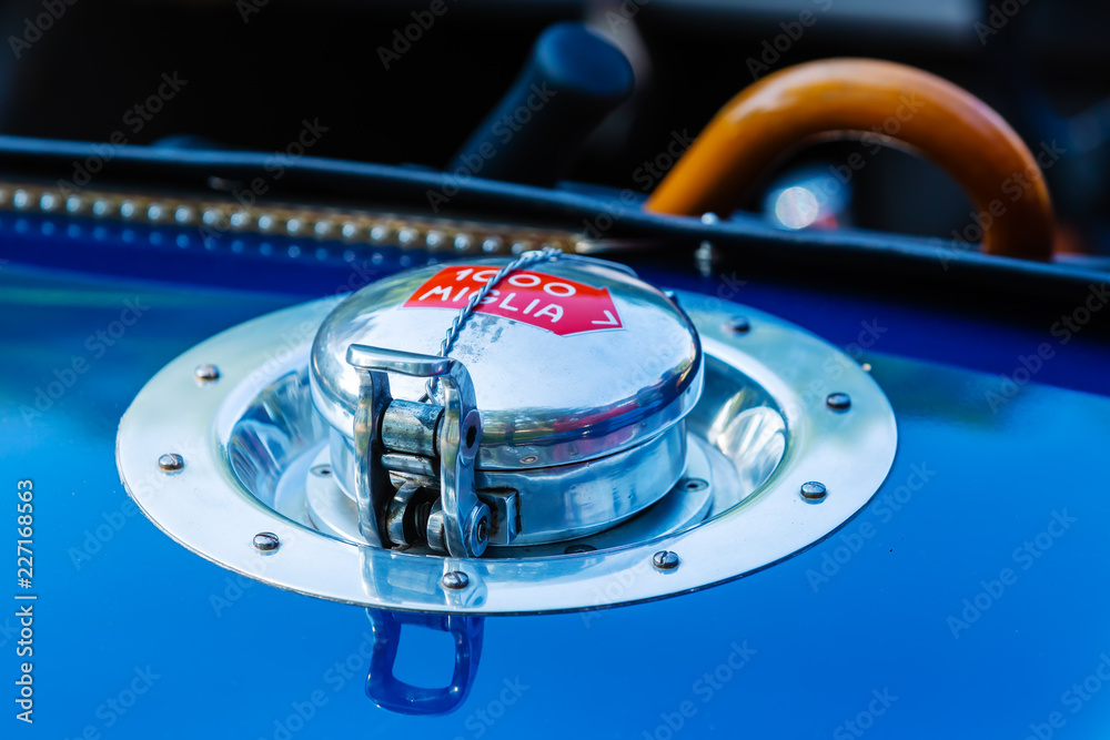 fuel filler port of a historical car with a mille miglia label, a ...