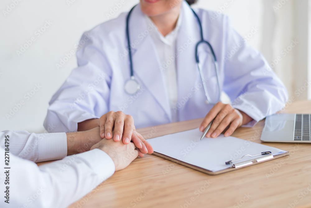 Close up of doctor touching patient hand for encouragement and empathy ...