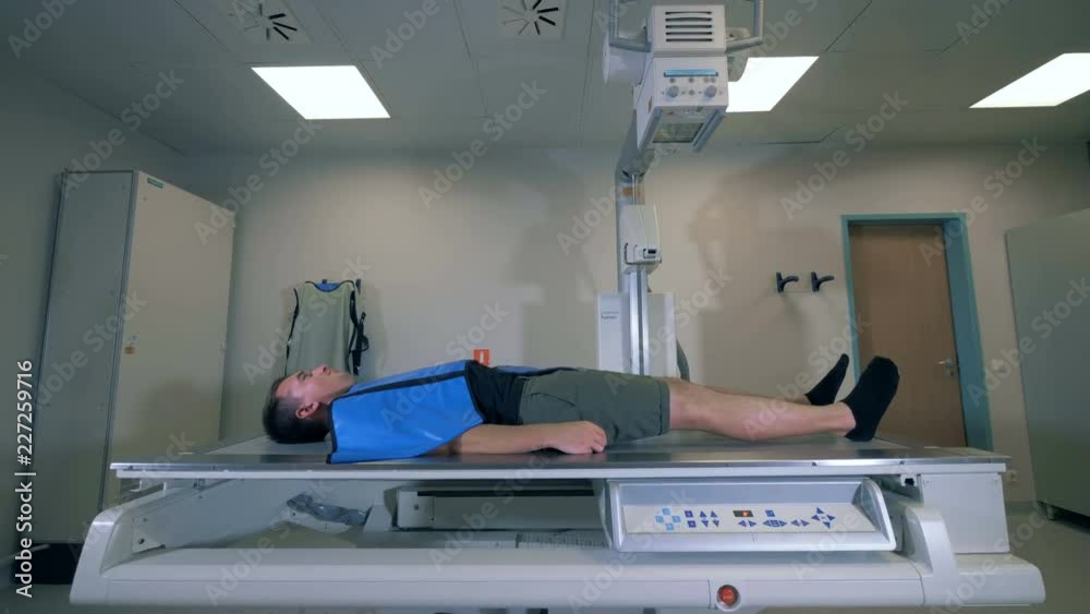 Man lying on a modern x-ray scanner machine. Stock Video | Adobe Stock
