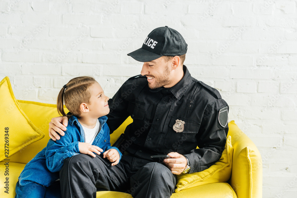 handsome young father in police uniform and son spending time together ...