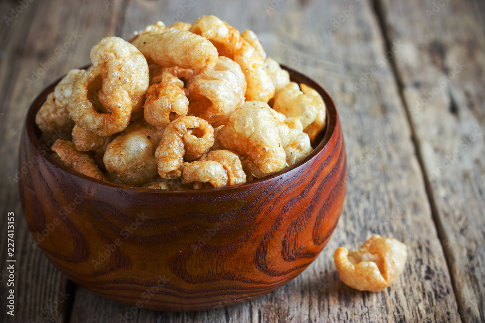 Chicharron - deep fried pork rinds, crispy pork skin pieces in wooden ...