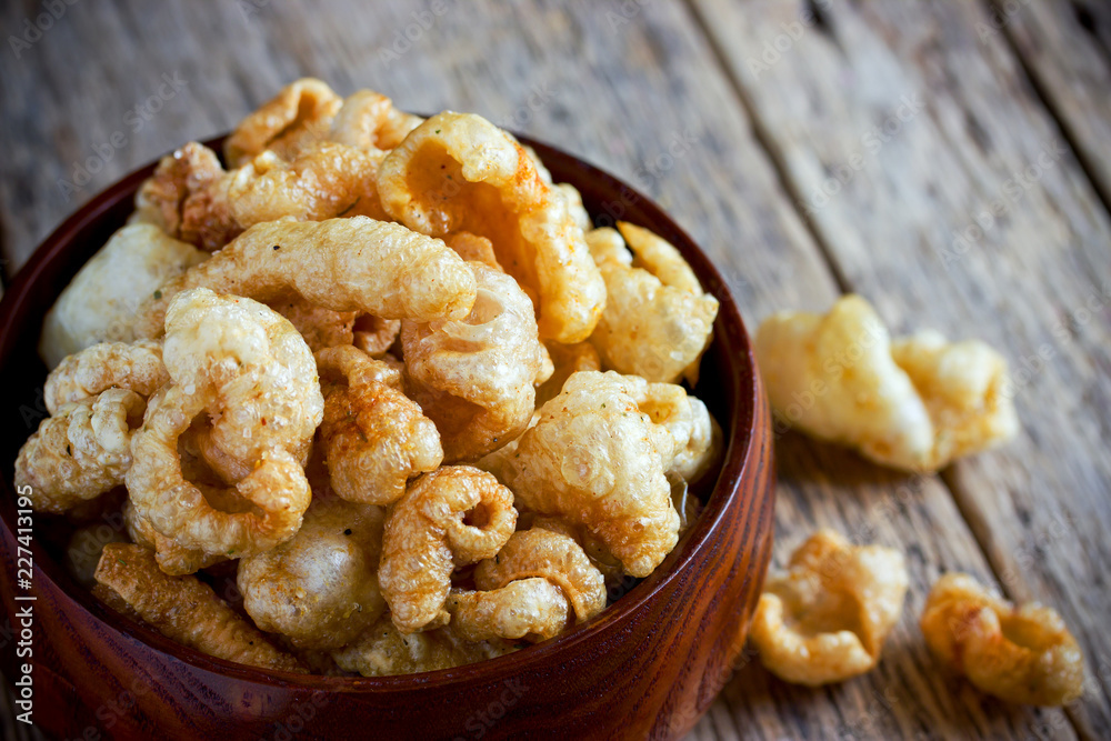 Chicharron - deep fried pork rinds, crispy pork skin pieces in wooden ...