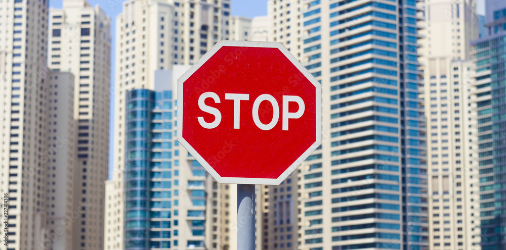 stop sign on the road in city with buildings background Stock Photo ...