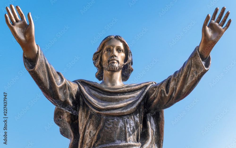 Bronze statue of Jesus looking at the sky with both arms up Stock Photo ...