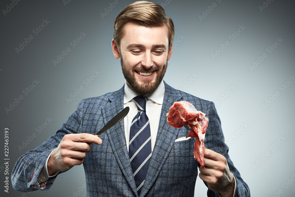 A man in a business suit with a piece of raw meat. Stock Photo | Adobe ...