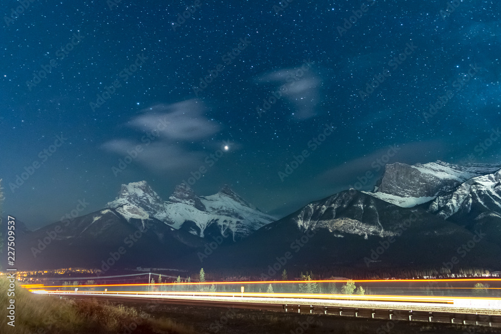 Trans Canadian Highway in Canmore, stars and Three Sisters in the background Stock Photo | Adobe ...