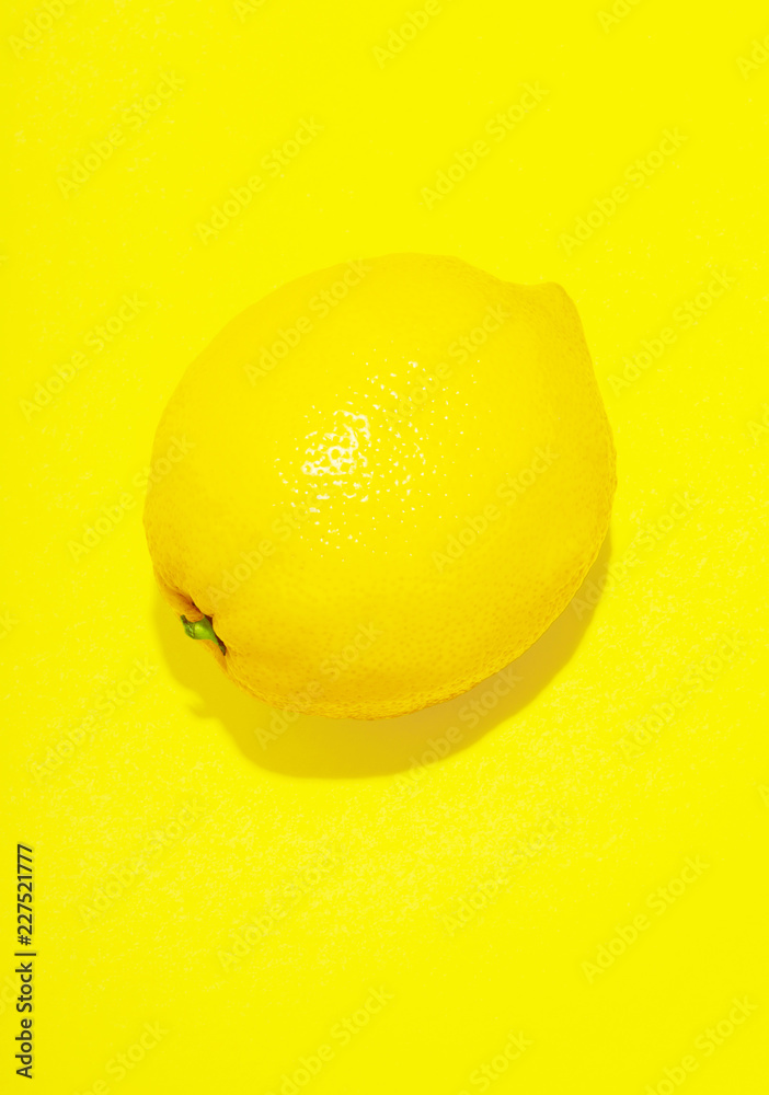 Lemon against yellow background Stock Photo | Adobe Stock