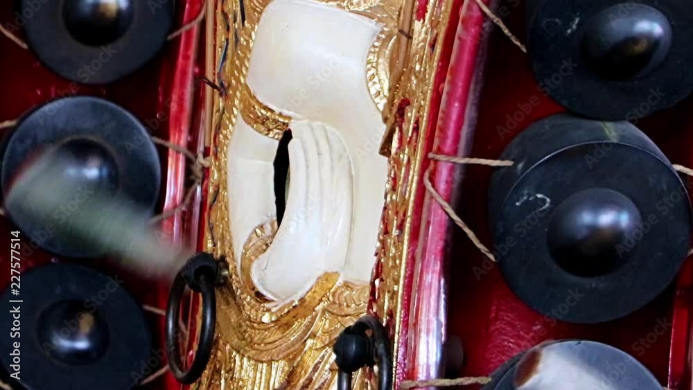 Playing a traditional musical instrument Khong Wong, close up view ...