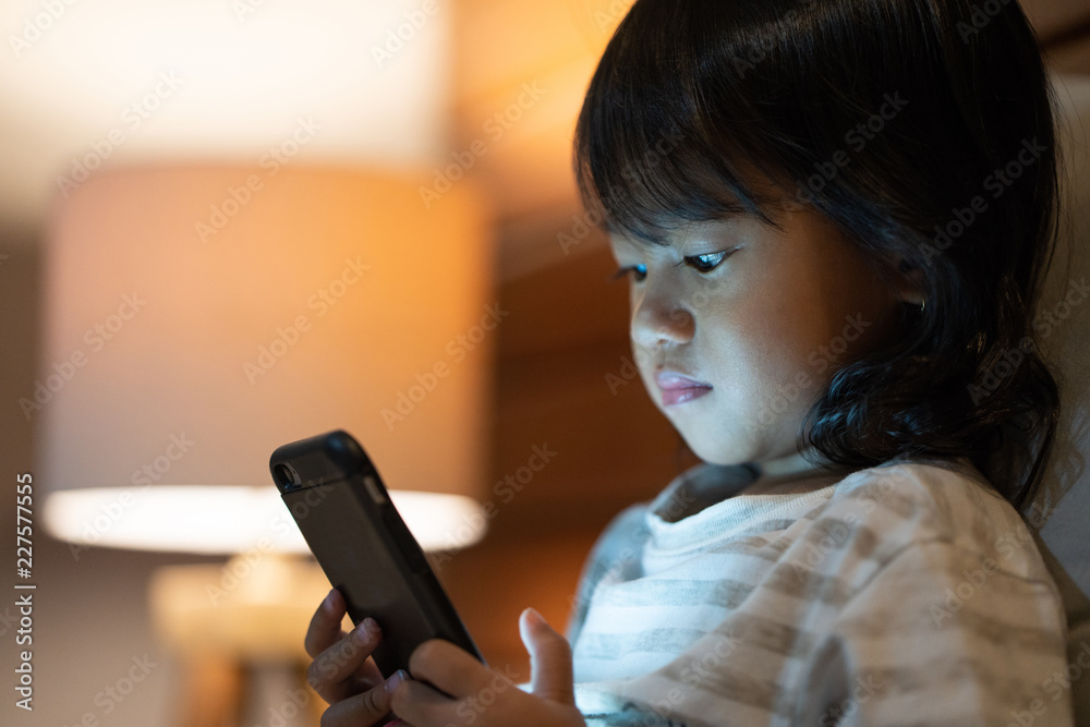 little girl with a mobile phone Stock Photo | Adobe Stock
