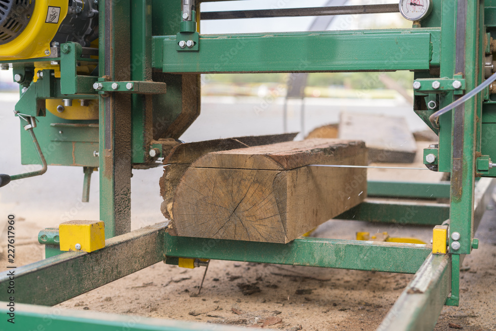 Sawmill. Process of machining logs in equipment sawmill machine saw ...