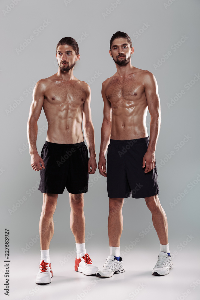 Full length portrait of a two muscular shirtless twin brothers Stock ...