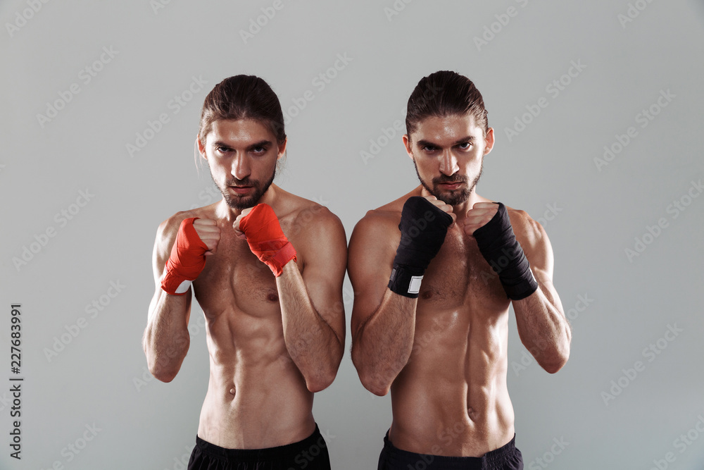 Portrait of a two confident muscular shirtless twin brothers Stock ...
